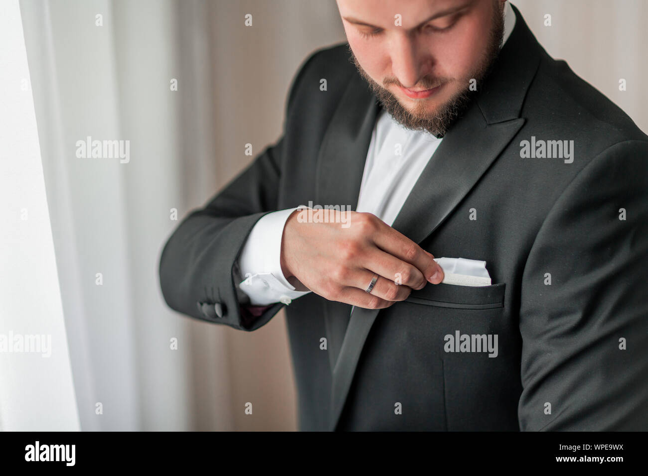 close up. serious man buttoning his jacket Stock Photo - Alamy