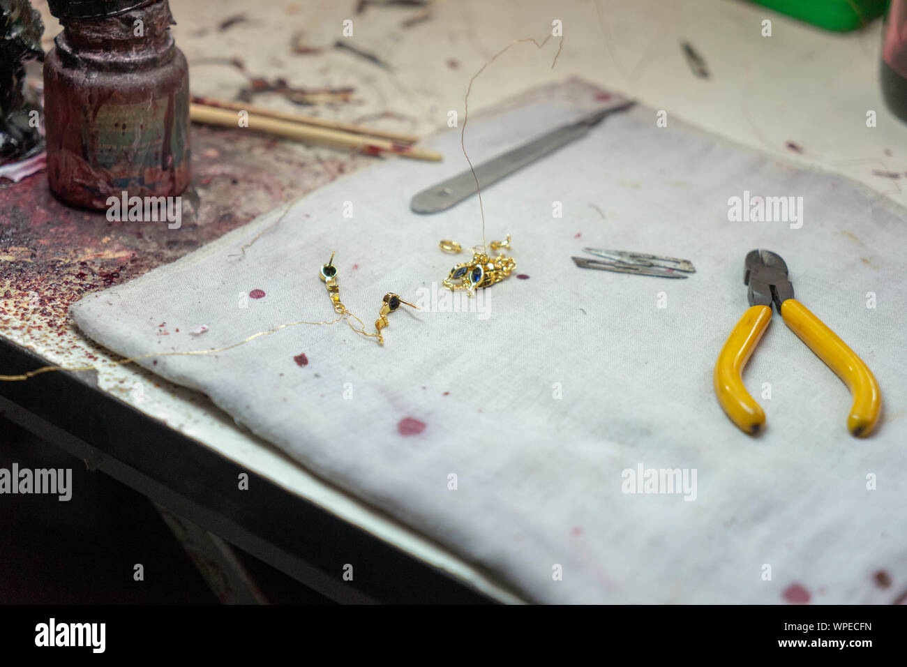 Golden bracelet and tools Stock Photo - Alamy