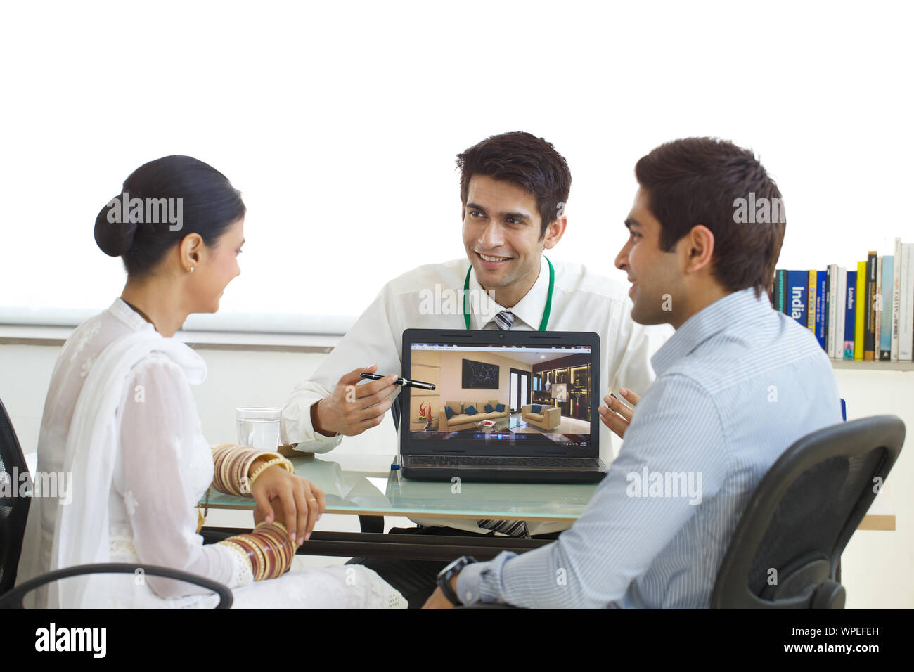 Real estate agent showing house plan on laptop Stock Photo - Alamy