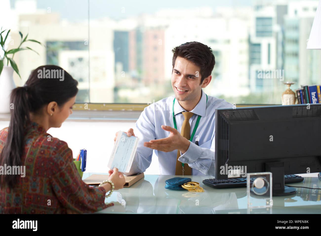 Bank manager giving loan cheque to a client Stock Photo - Alamy