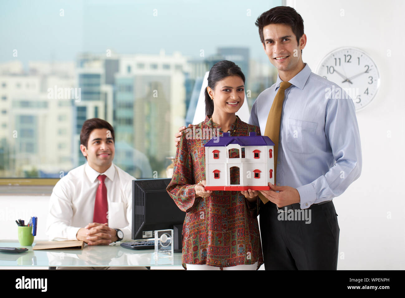 Young couple showing model of dream home Stock Photo - Alamy