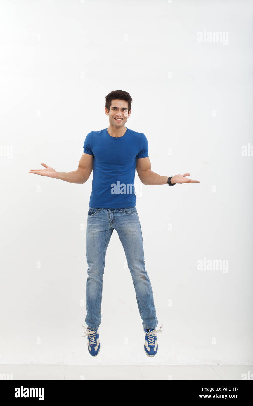 Young man jumping in mid air Stock Photo - Alamy