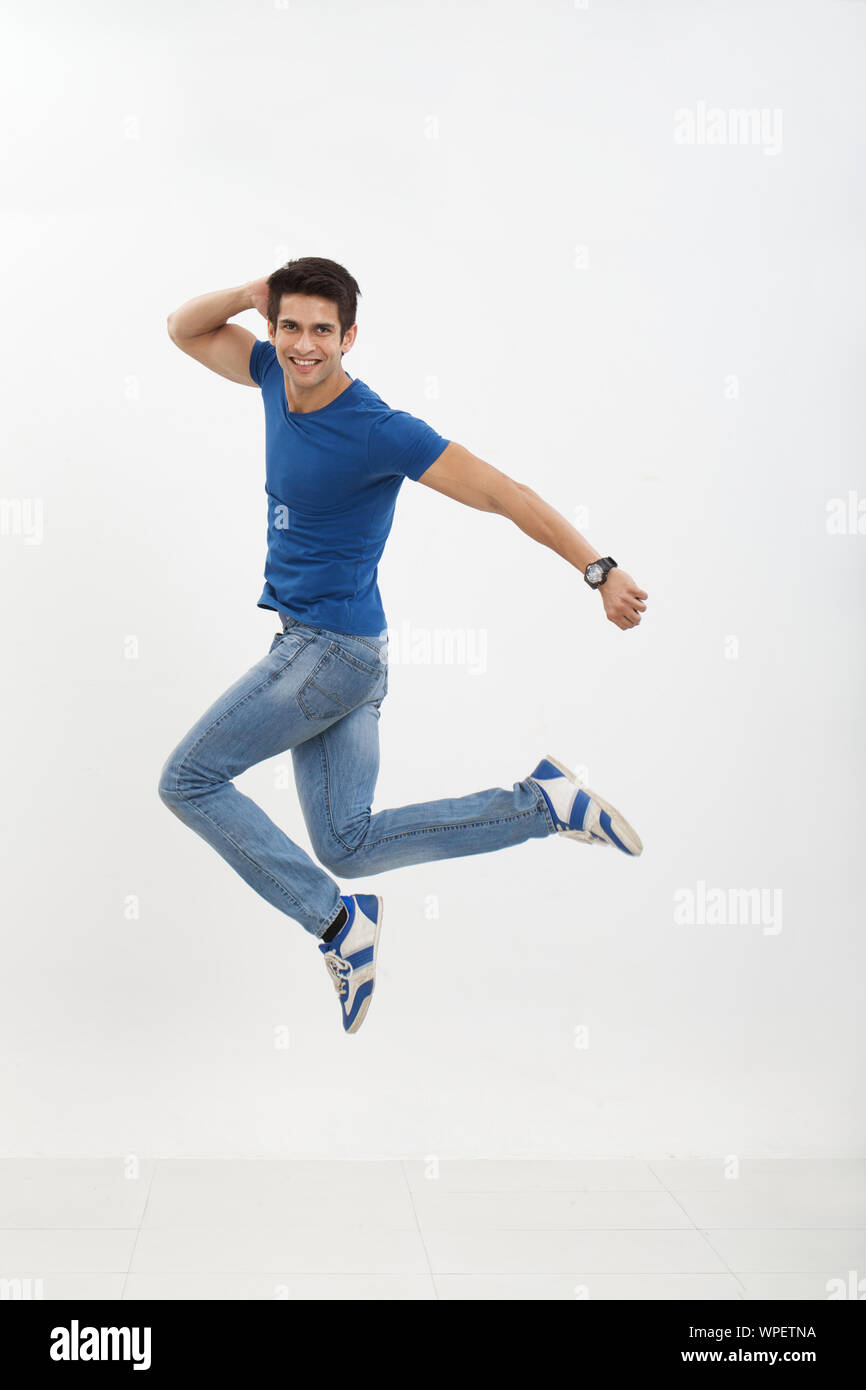 Young man jumping in mid air Stock Photo - Alamy