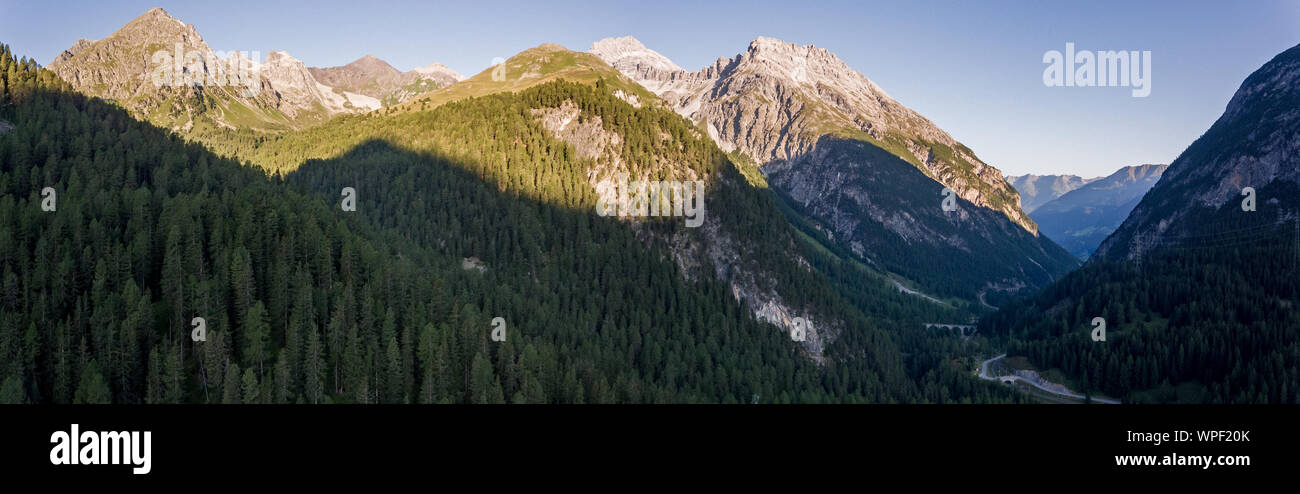 Aerial drone views of a lush green alpine valley and the surrounding ...