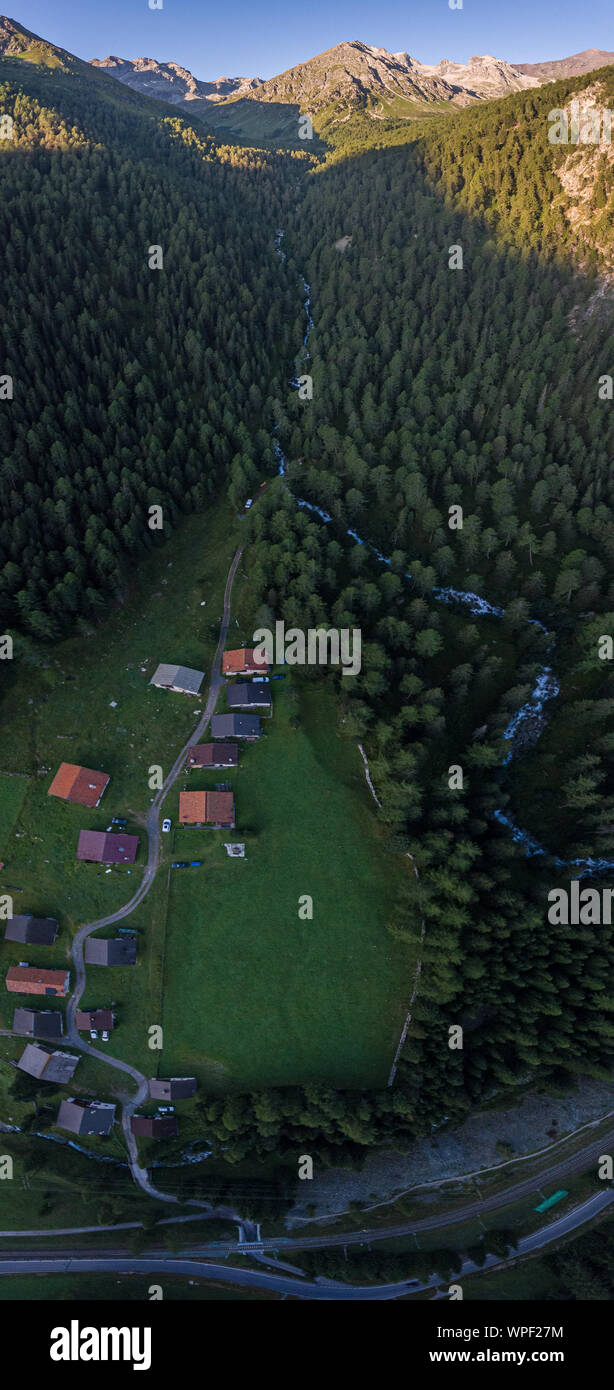 Aerial drone views of a lush green alpine valley and the surrounding ...