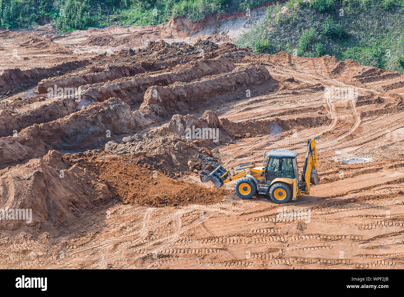 Wheel loader excavator machine working in construction site. wheel ...