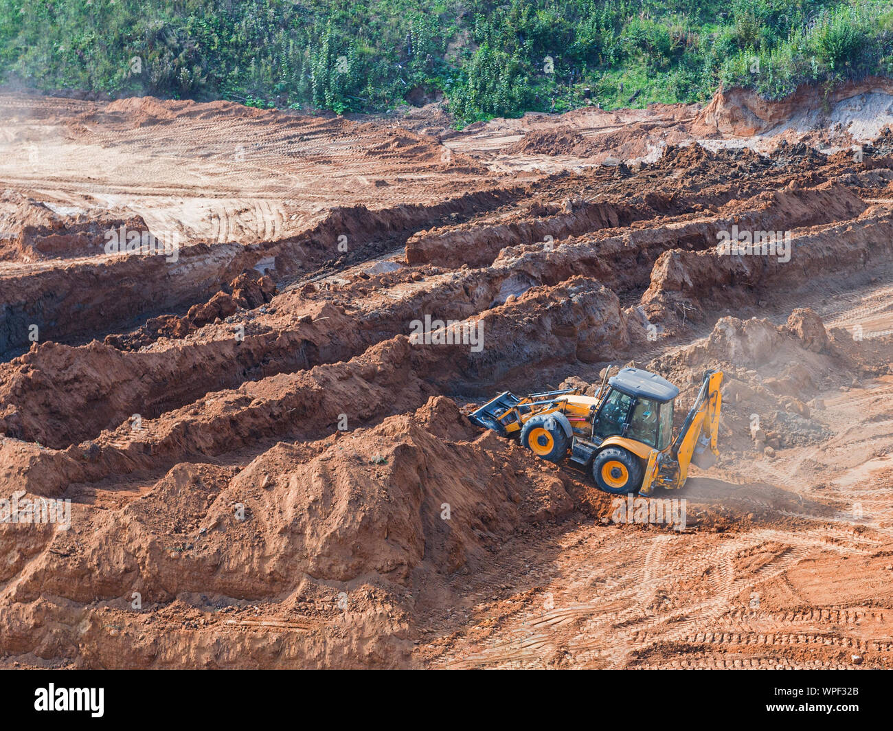 Wheel loader excavator machine working in construction site. wheel ...
