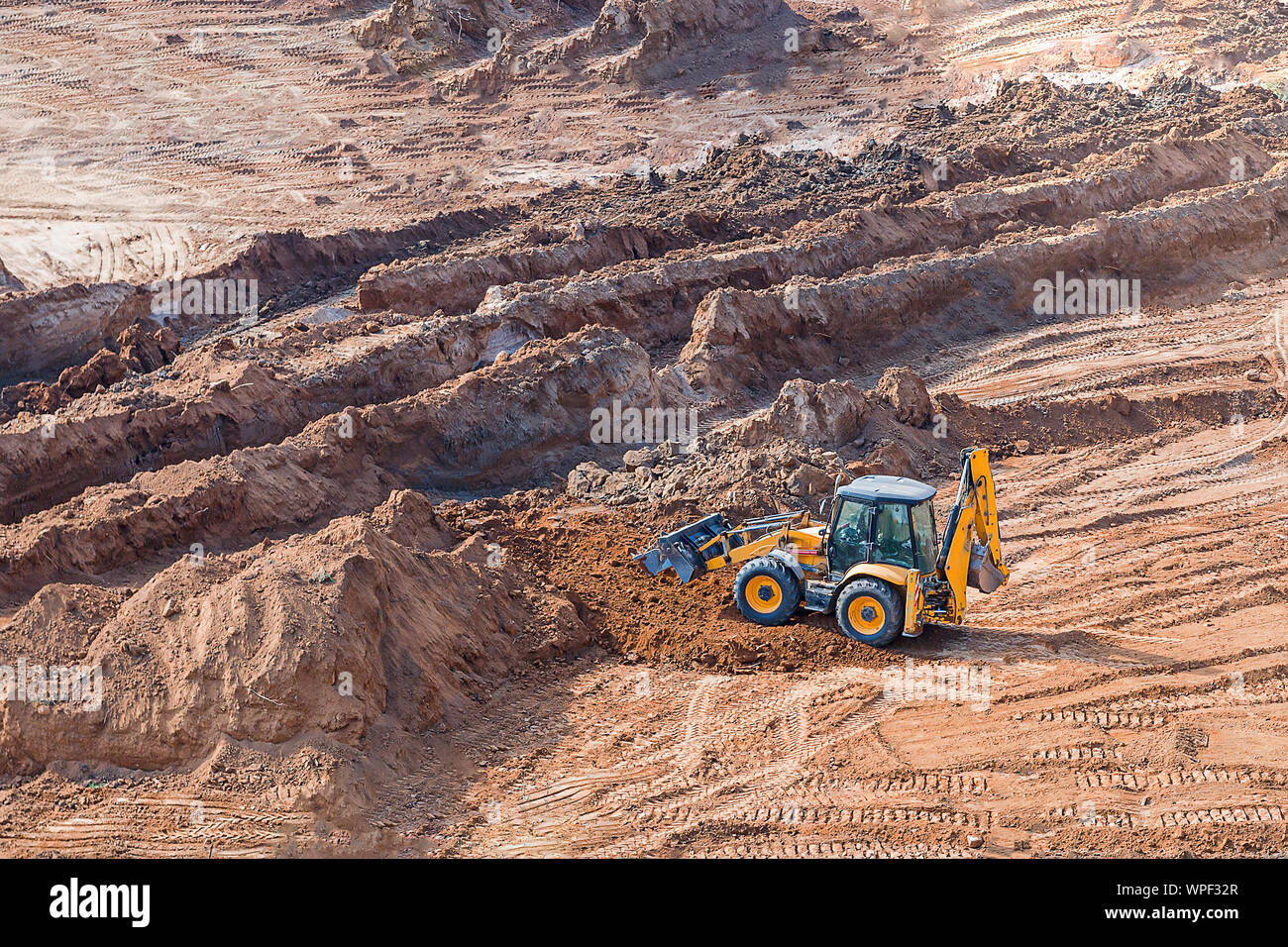 Wheel loader excavator machine working in construction site. wheel ...