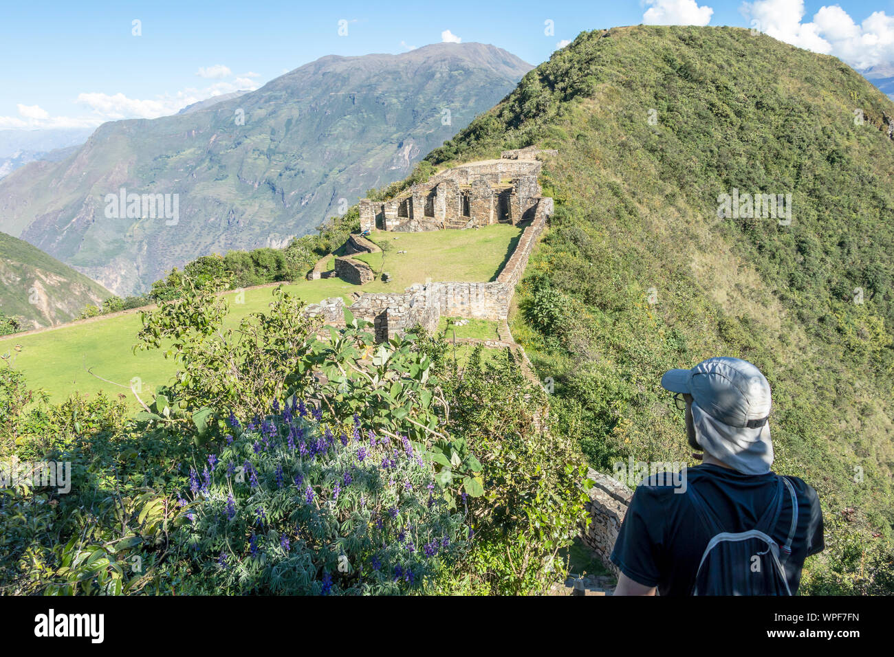 Young tourist with backpack hiking at high altitude Peruvian mountains ...