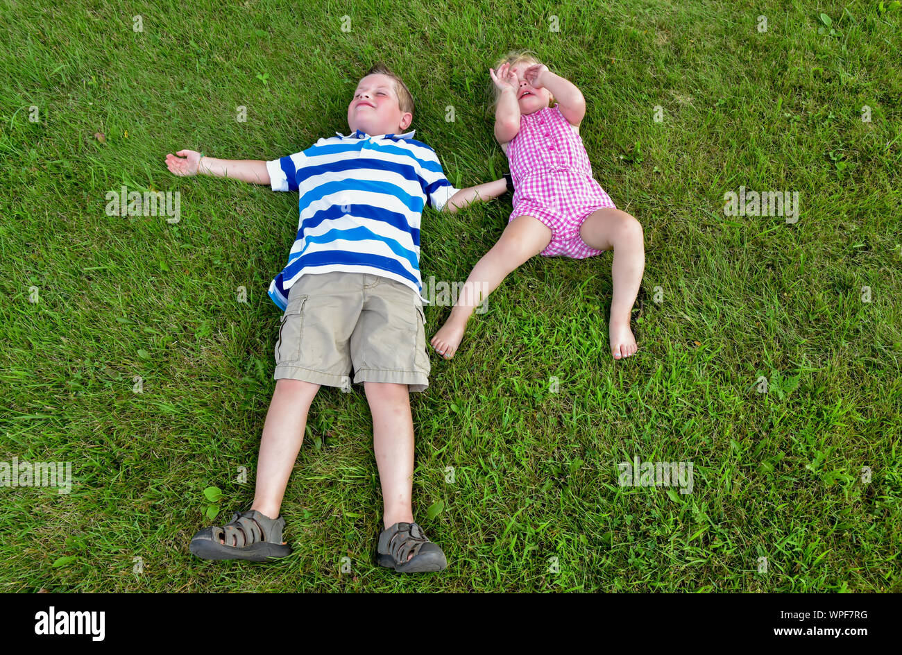 Two children lying hi-res stock photography and images - Alamy