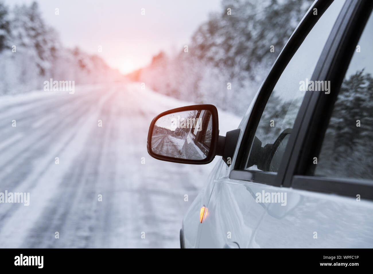 The winter road is reflected in the car's rear-view mirror Stock Photo ...