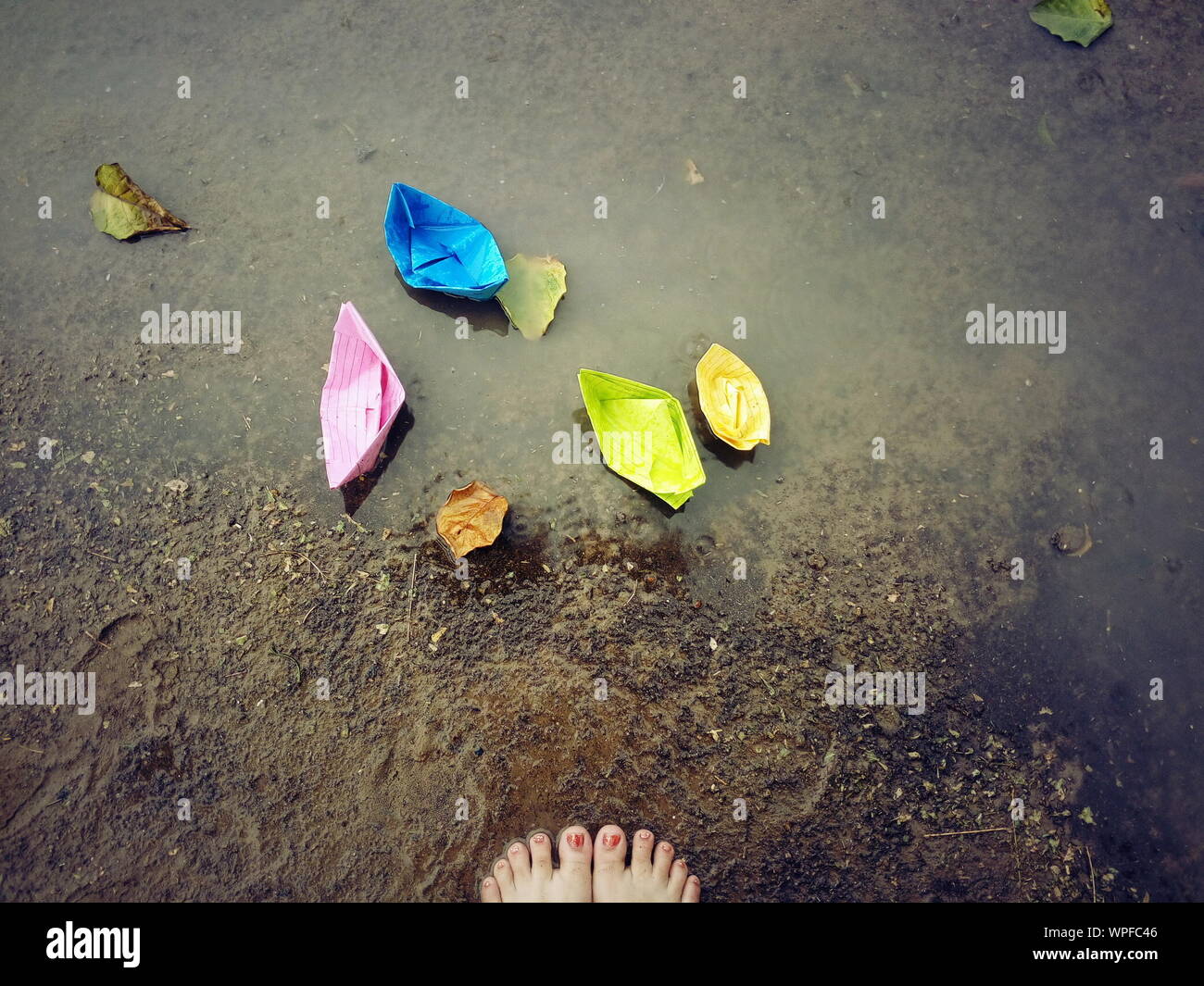 Paper boat puddle hi-res stock photography and images - Alamy