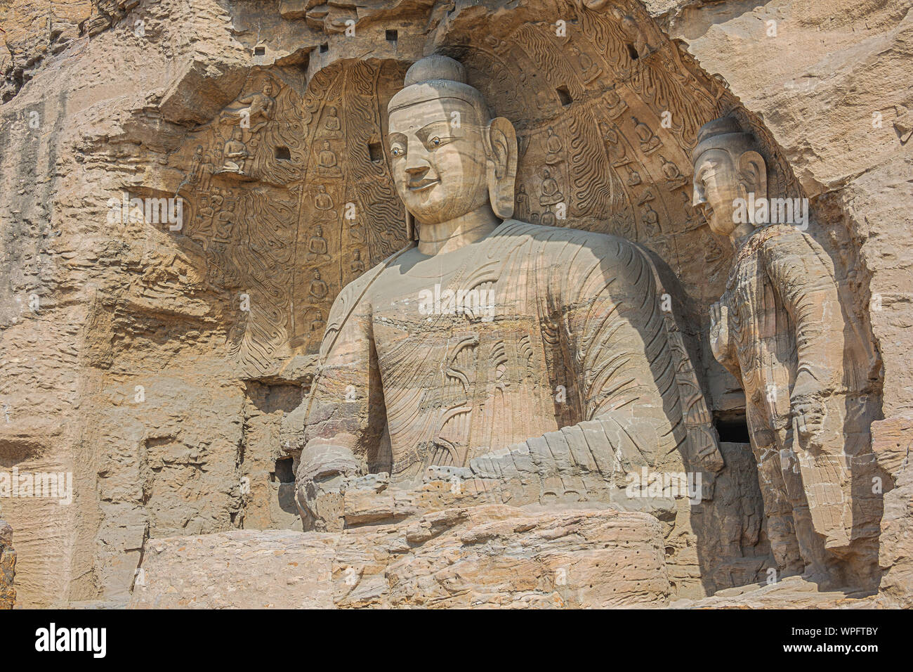 Two Buddha statues in a niche in the Yungang Grottoes near Datong Stock ...