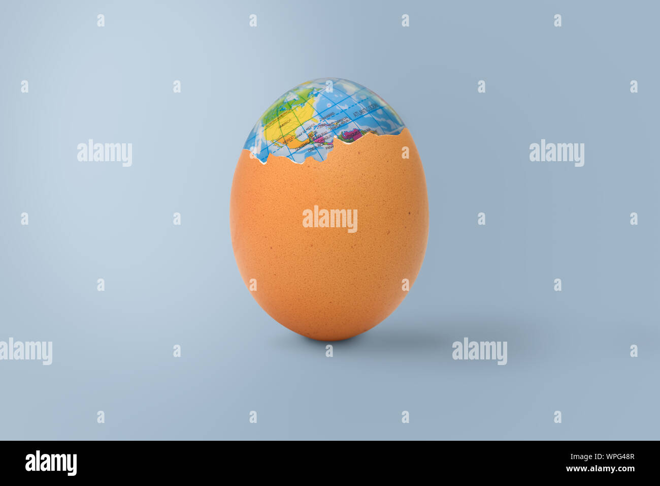 The shelled egg has an globe inside. easter concept Stock Photo - Alamy