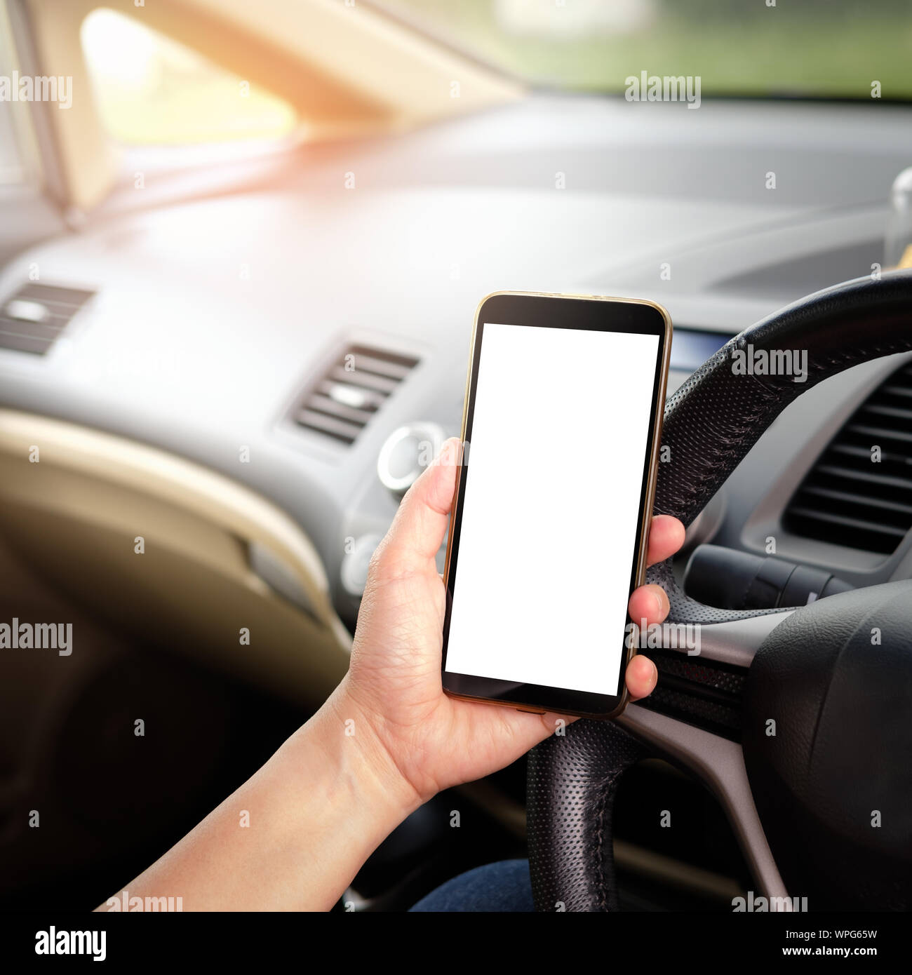 Hand is holding a touch phone with isolated screen in the car Stock ...
