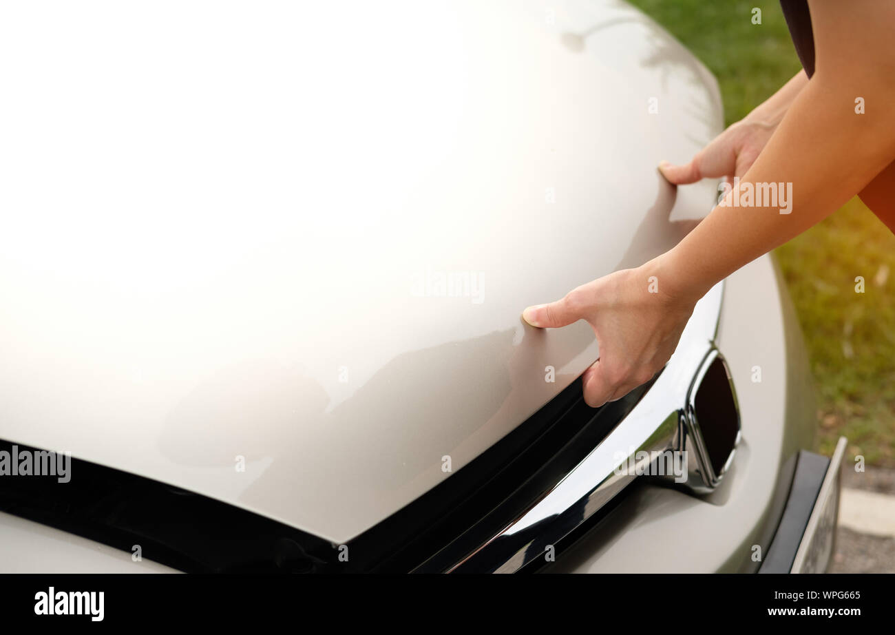 Hands is opening bonnet to check engine Stock Photo - Alamy