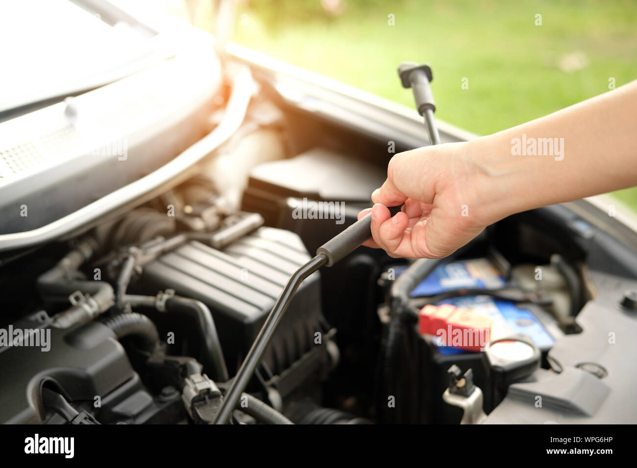 The car is opening the hood to check the engine oil Stock Photo - Alamy