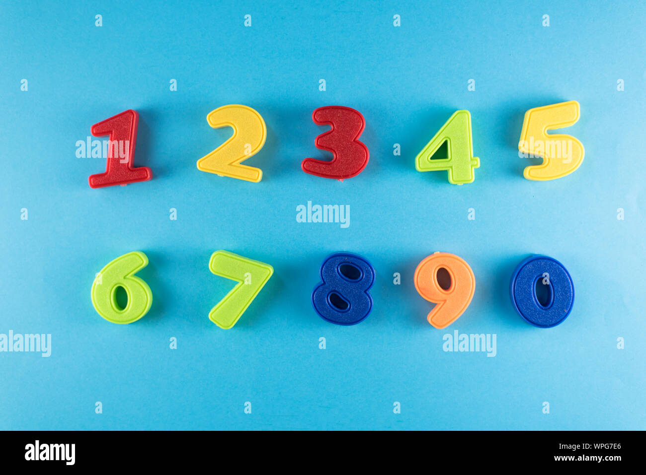 group of numbers from plastic toy against blue background. concept of ...