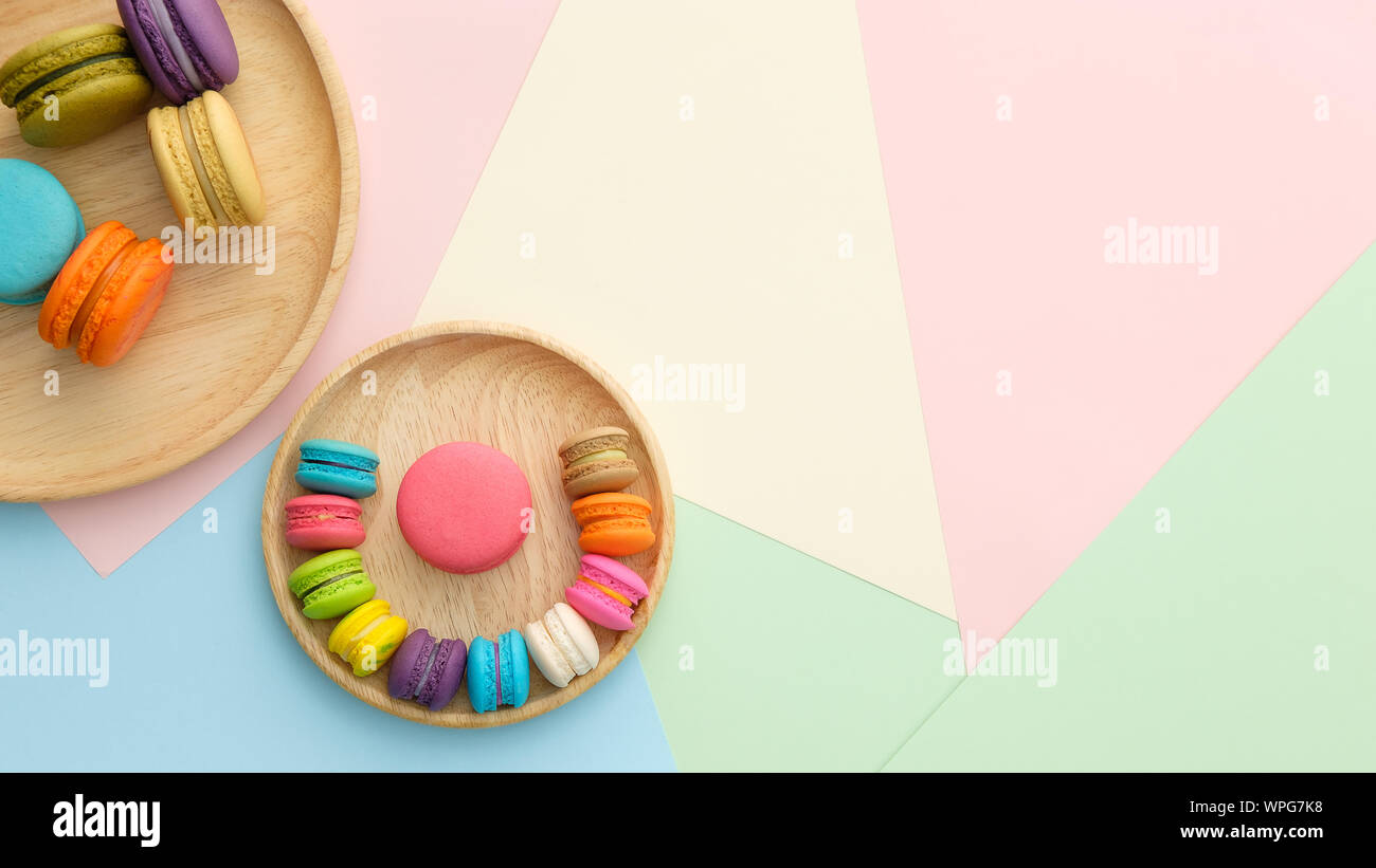 Set of different colorful macaroons Placed in a wooden tray, on many ...
