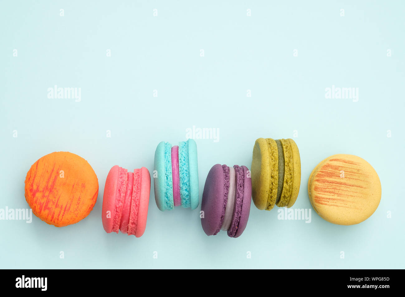 colorful macaroons on turquoise background, Sweet and tasty for cooking ...