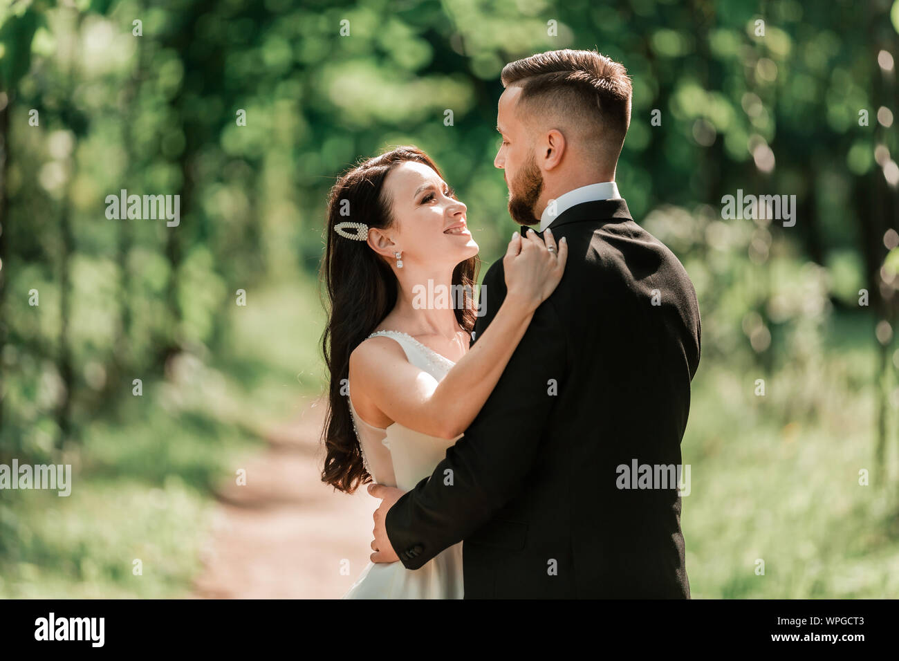 happy bride and groom standing under the wedding arch Stock Photo - Alamy