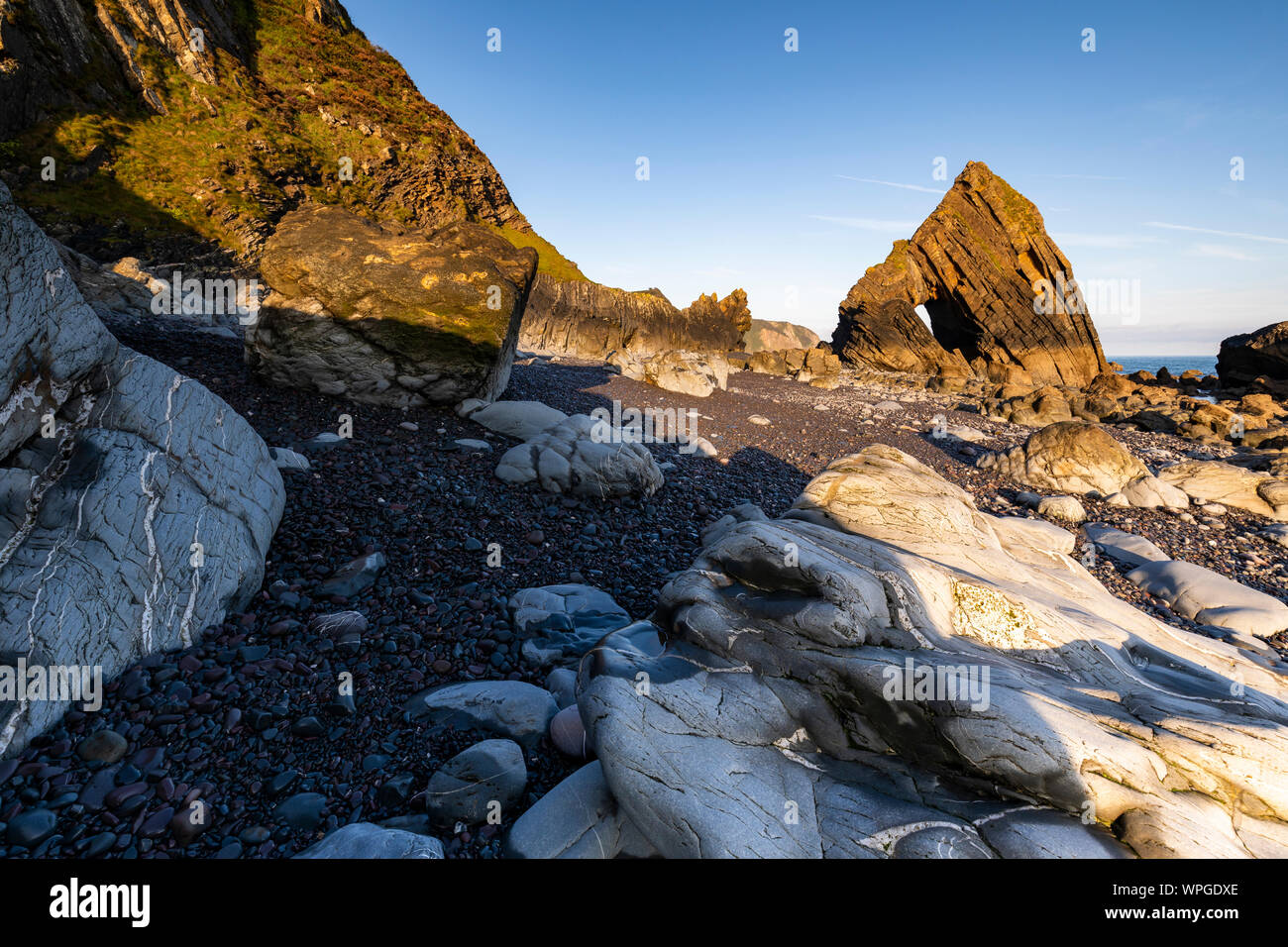 Sunrise illuminates Blackchurch Rock at Mouthmill Beach on the North ...