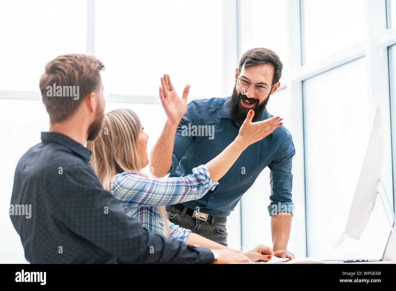 young professionals giving each other a high five Stock Photo - Alamy