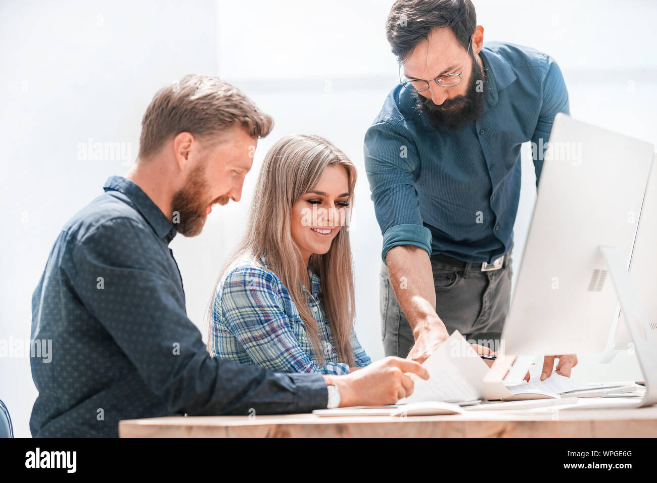 employees discussing business documents in the workplace Stock Photo ...