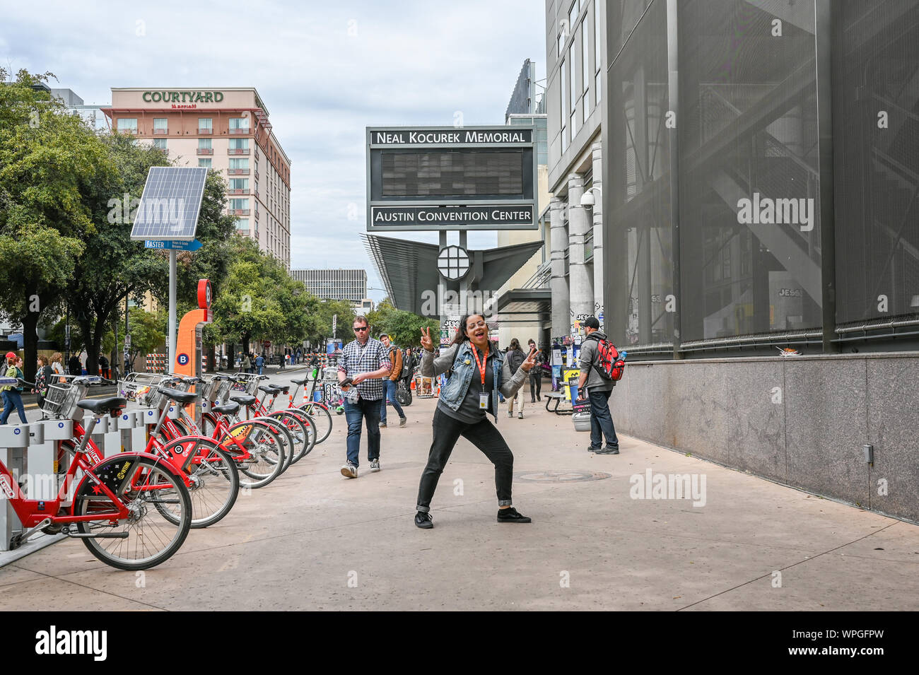 Cheerful visitors of the SXSW festival pose outside Austin Convention ...