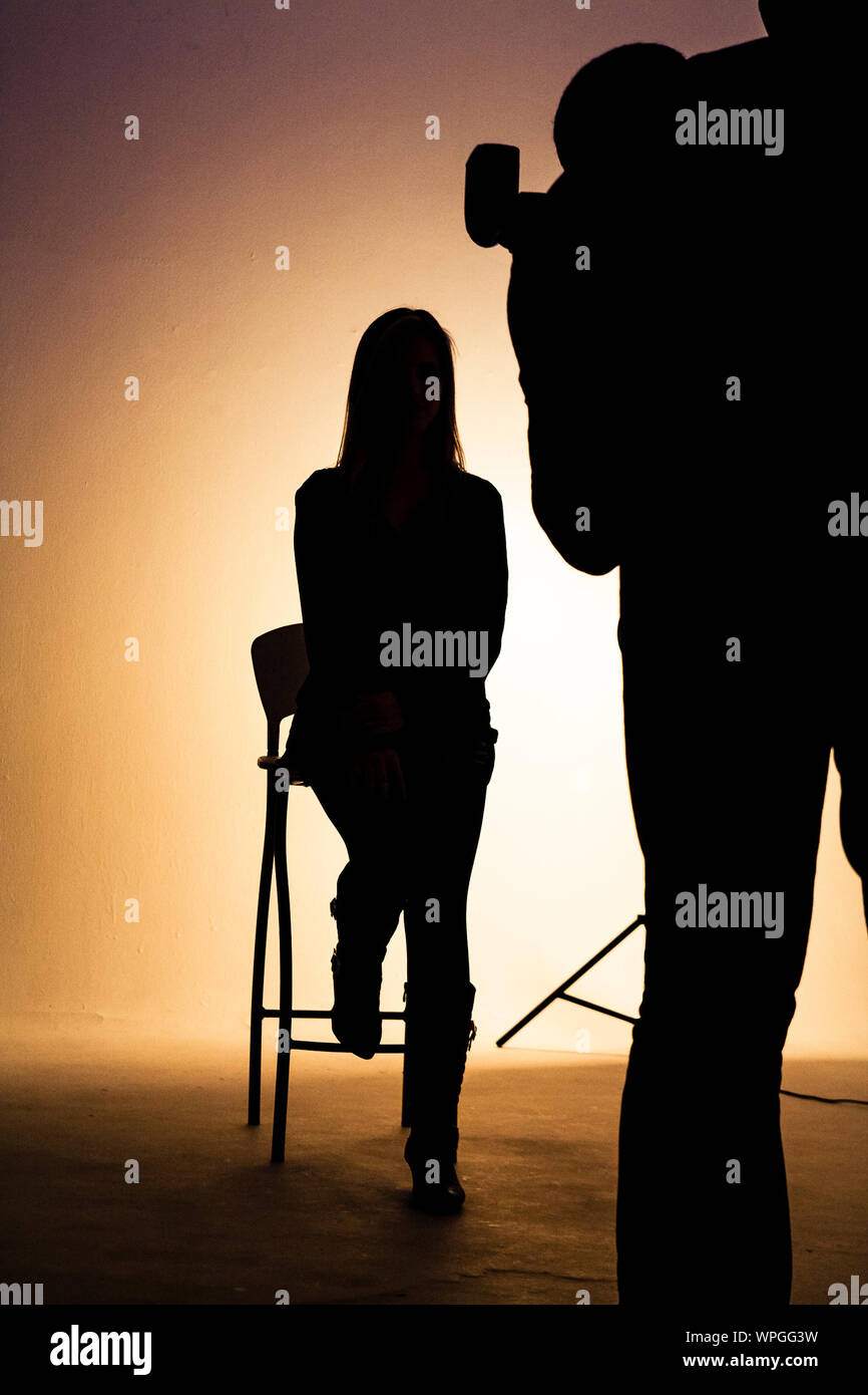 Silhouette Man Photographing Woman In Studio Stock Photo - Alamy