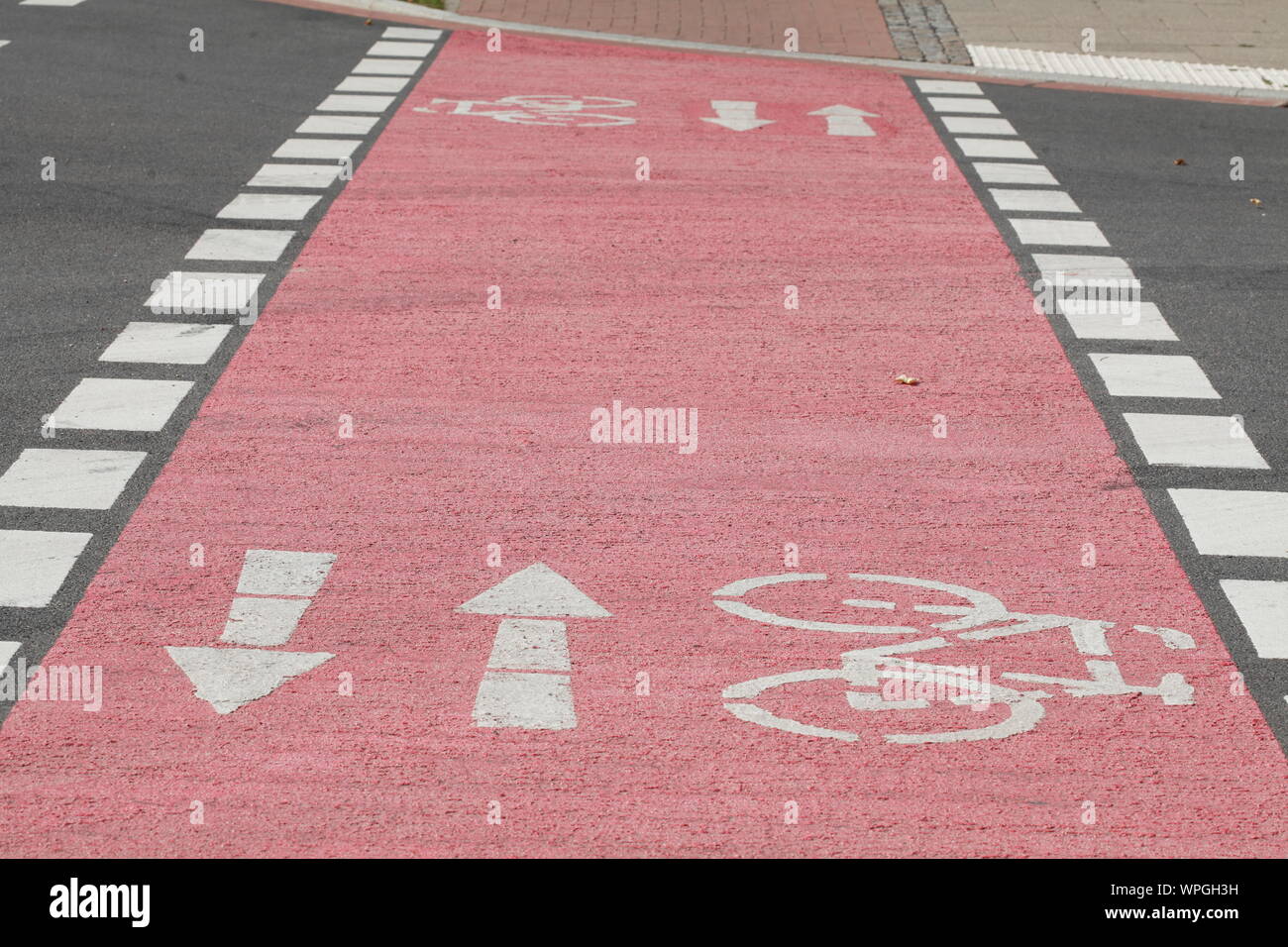 Red bike lane with ground marking, Germany Stock Photo - Alamy