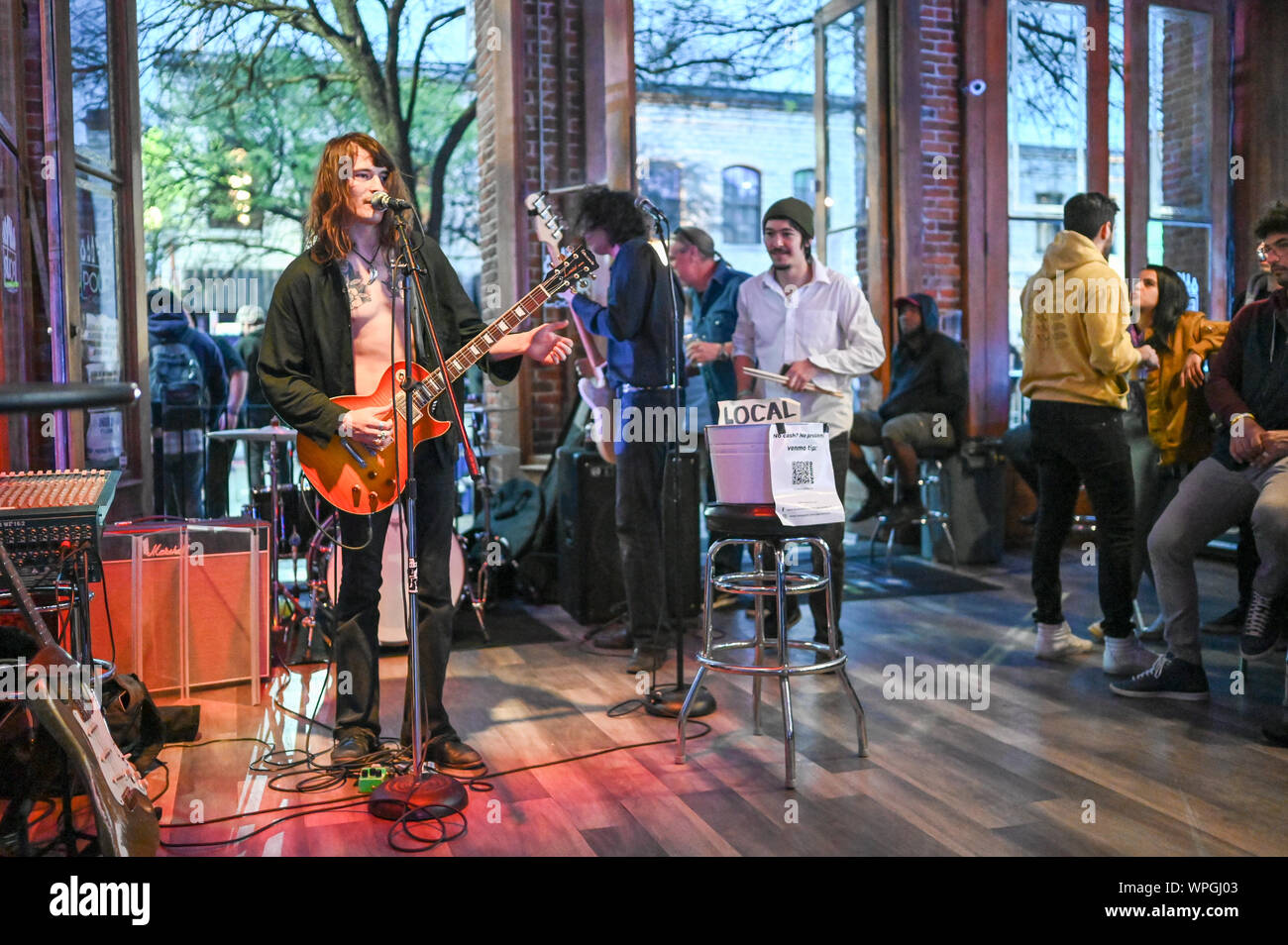 Paul Val plays the guitar at Pour Choices on Sixth Street in Austin ...