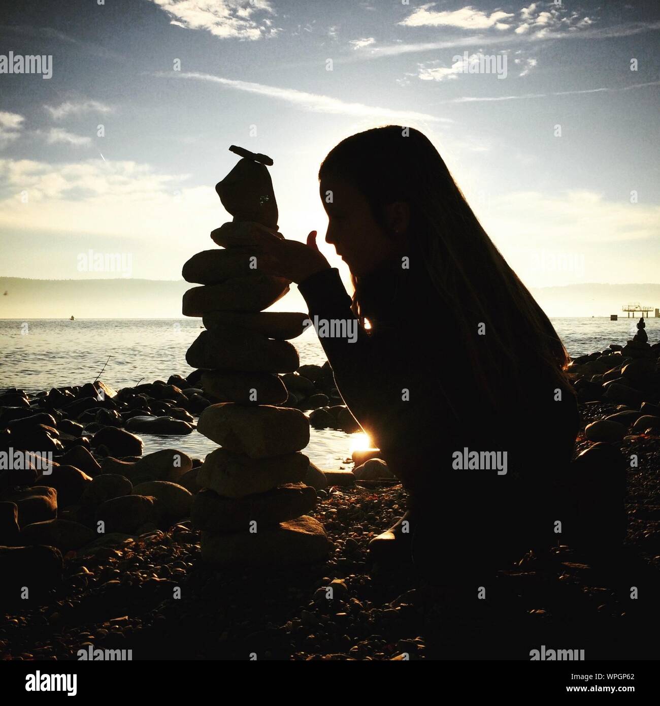 Child stacking rocks hi-res stock photography and images - Alamy