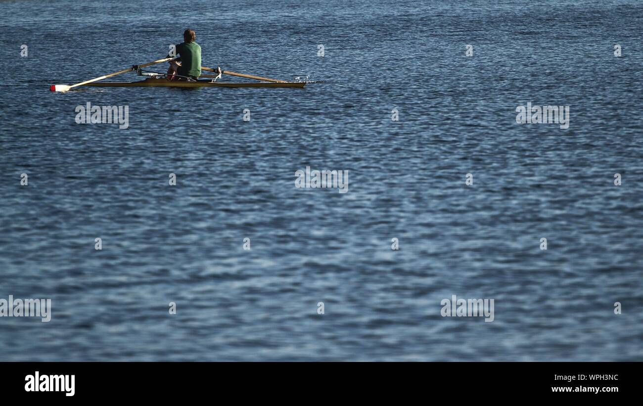 Man rowboat blue hi-res stock photography and images - Alamy