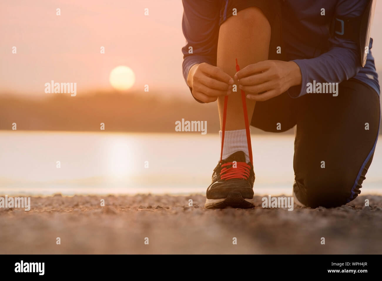 Close up woman tying shoe laces,sport concept Stock Photo - Alamy