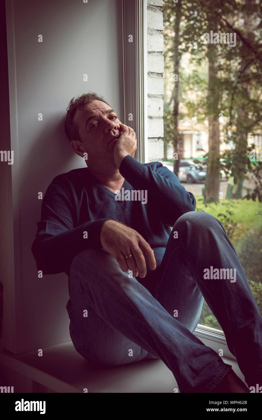 Sad man window hi-res stock photography and images - Alamy