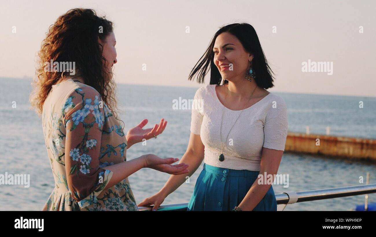Two women beach talking hi-res stock photography and images - Alamy