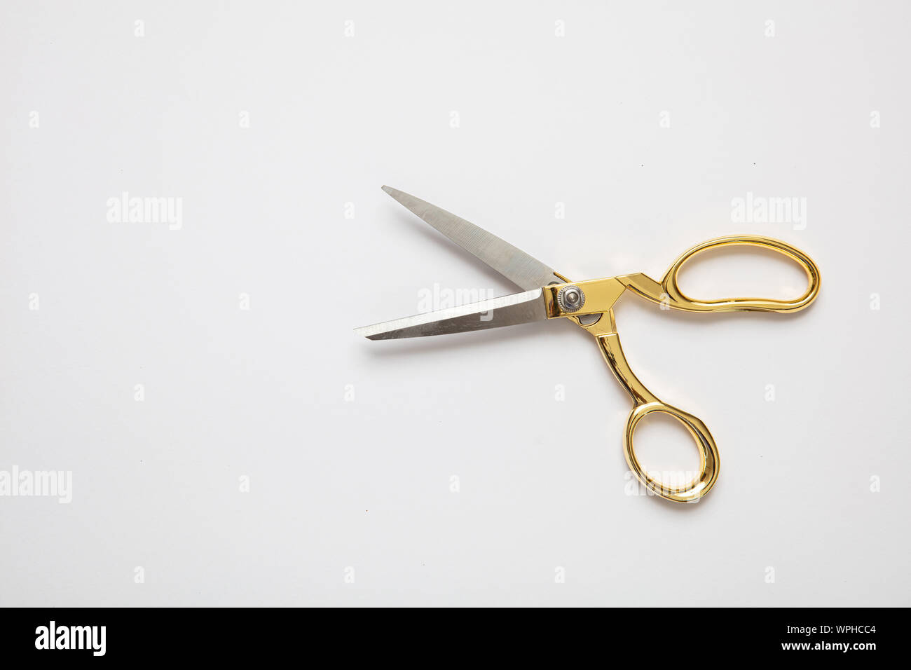 Scissors open gold and silver color isolated against white background ...