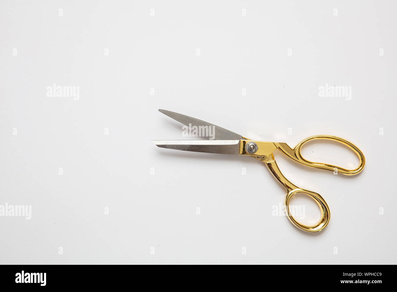 Scissors open gold and silver color isolated against white background ...