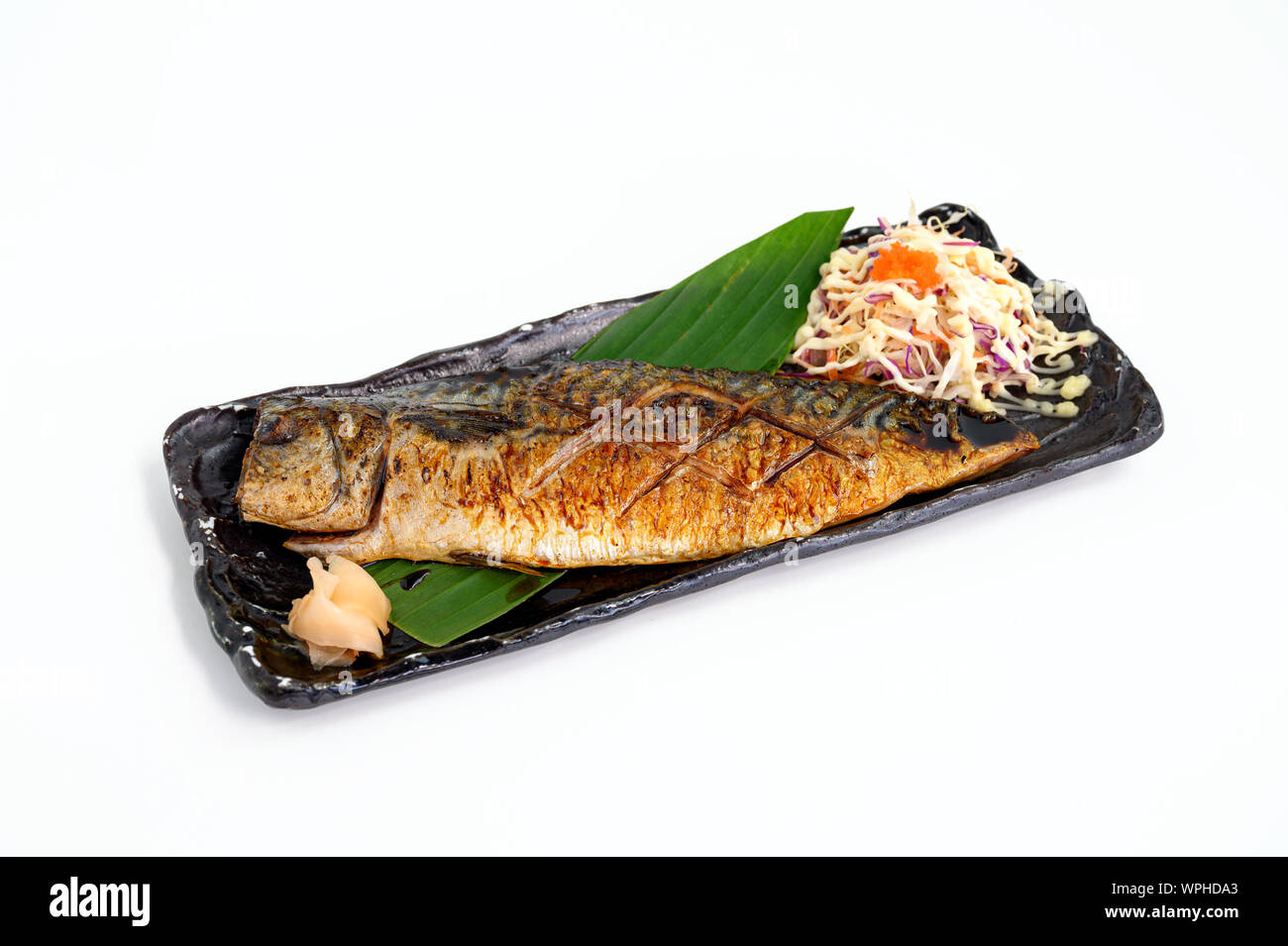 Grilled saba fish with soy sauce and salt with vegetable on ceramic ...