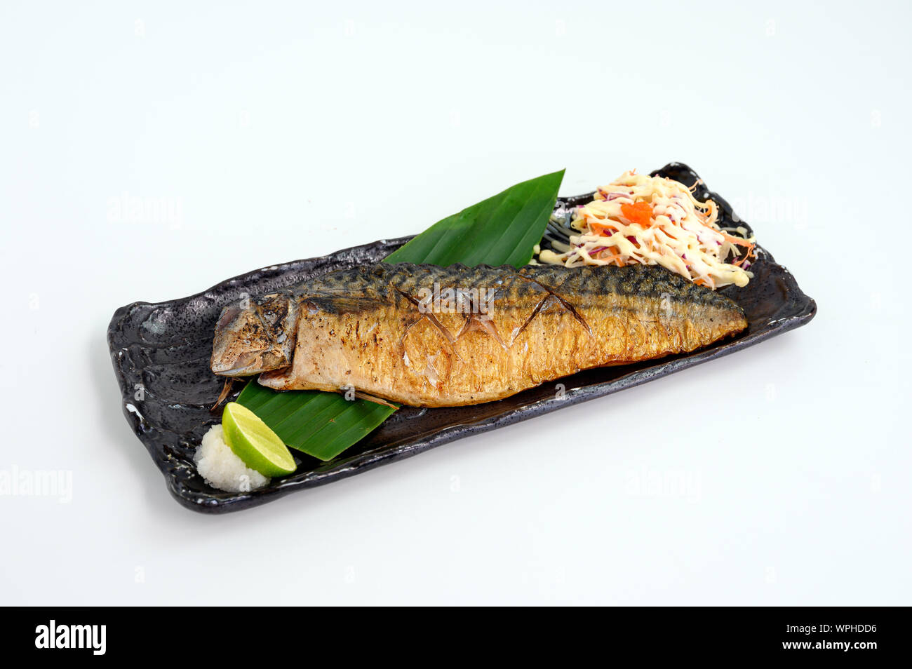Grilled saba fish with soy sauce and salt with vegetable on ceramic ...