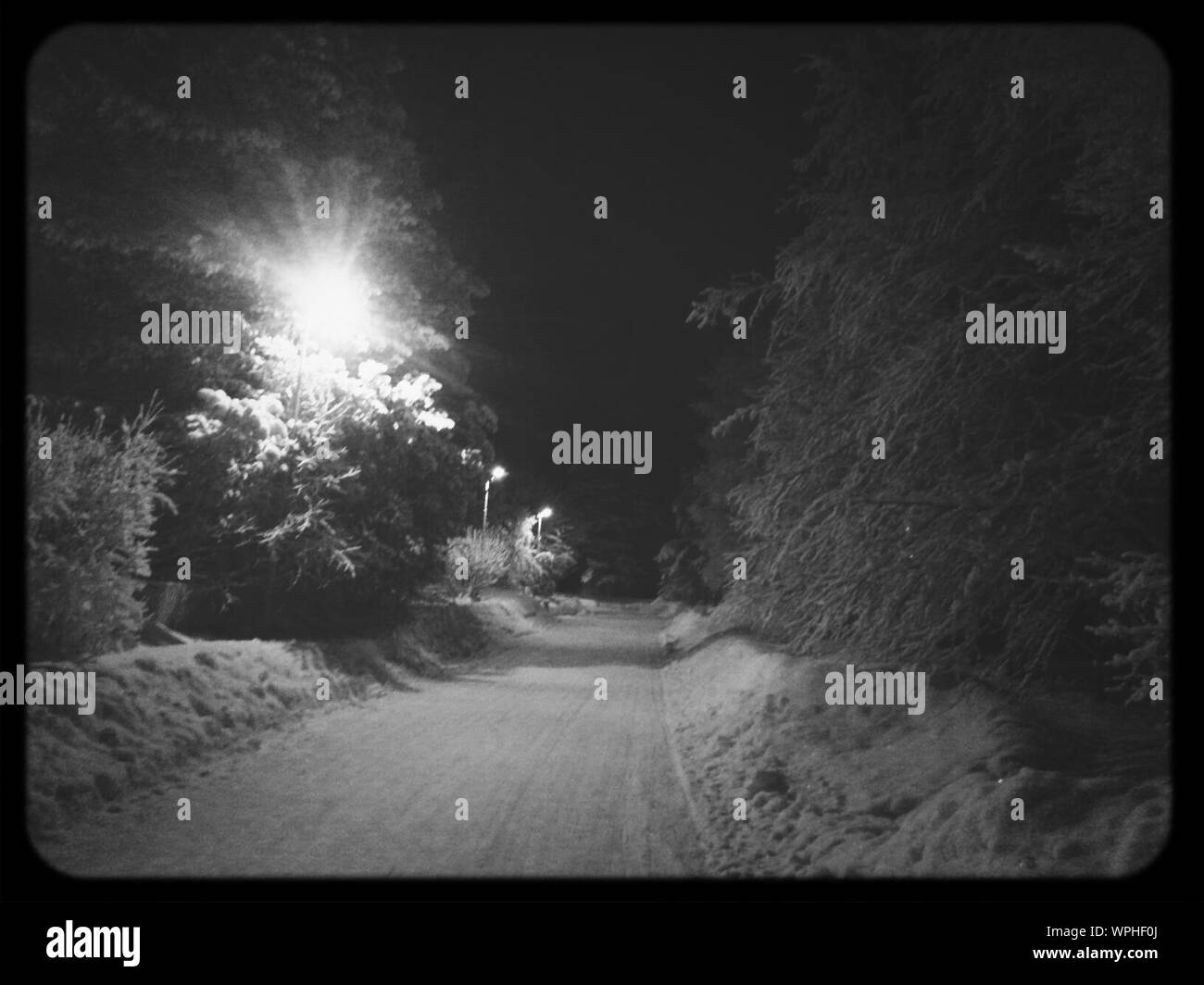 Snow Covered Road At Night Stock Photo - Alamy