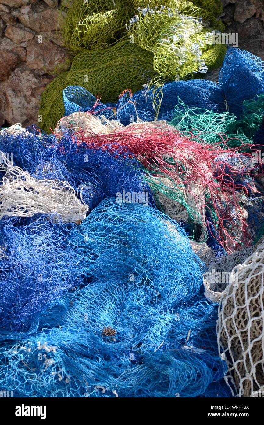 Fishing Net On Rocks Stock Photo - Alamy