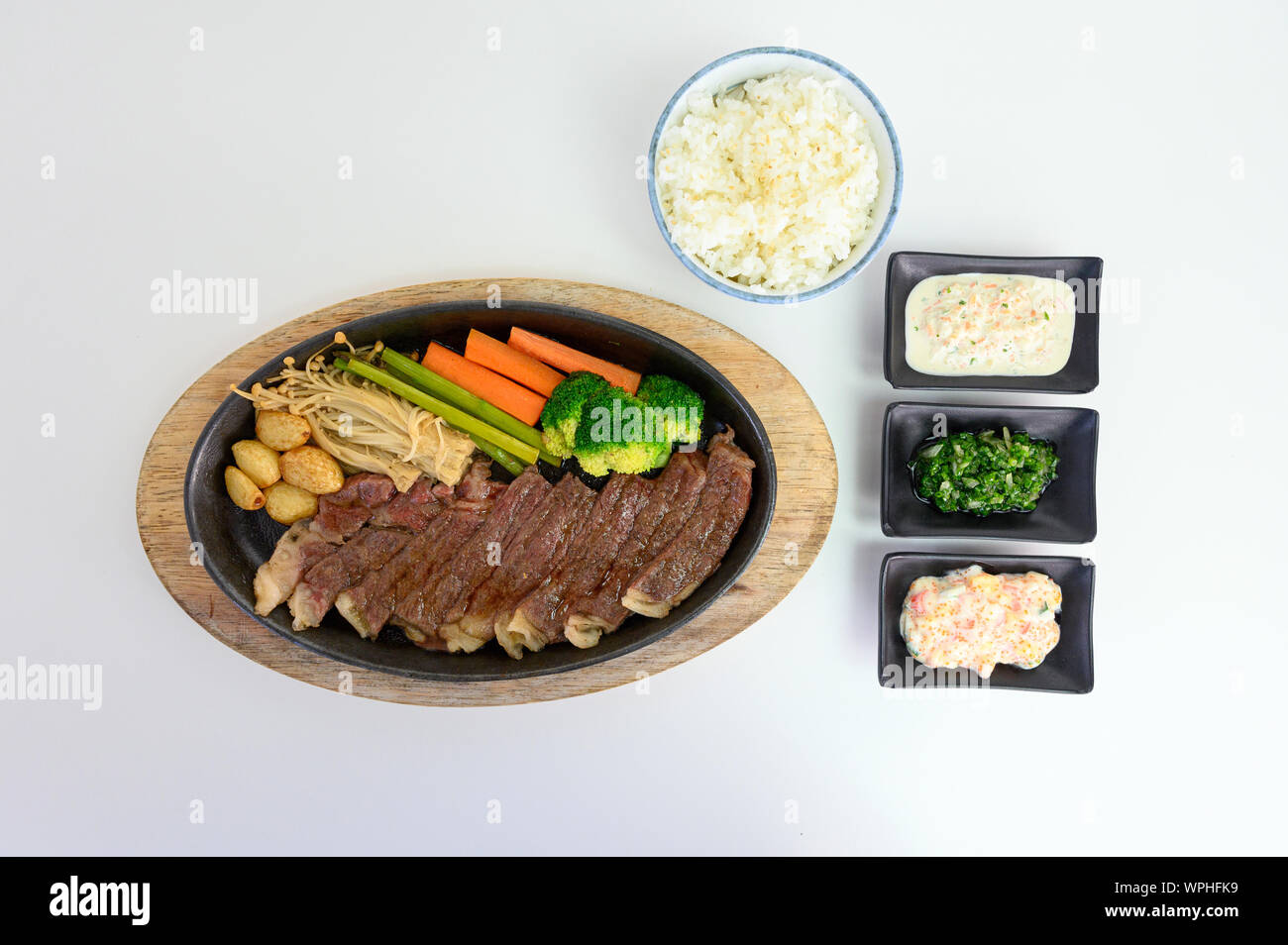 Japanese wagyu beef slices set with vegetables and sauce in pan on ...