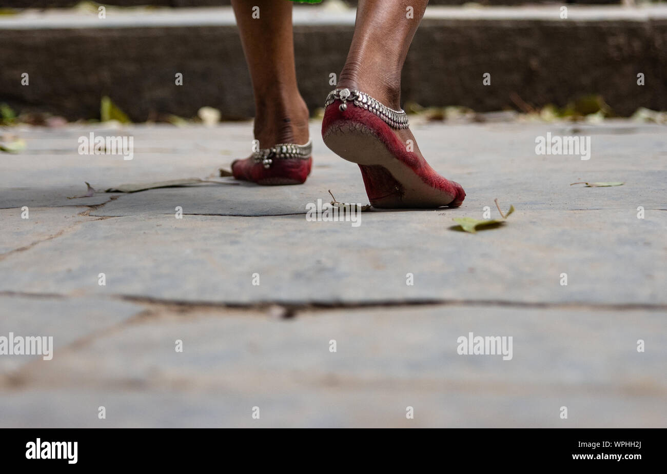 A hindu woman wearing Silver Pauju (Anklets) walks bare foot on the ...