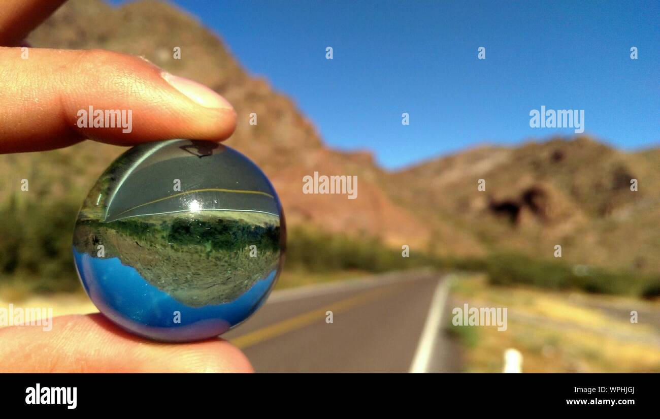 Hand holding marbles hi-res stock photography and images - Alamy