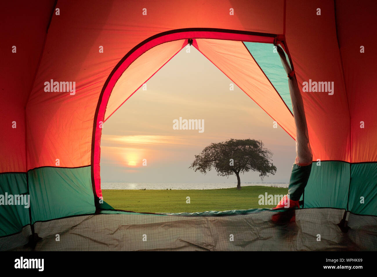 Tent view on window with sunset or sunrise background Stock Photo - Alamy