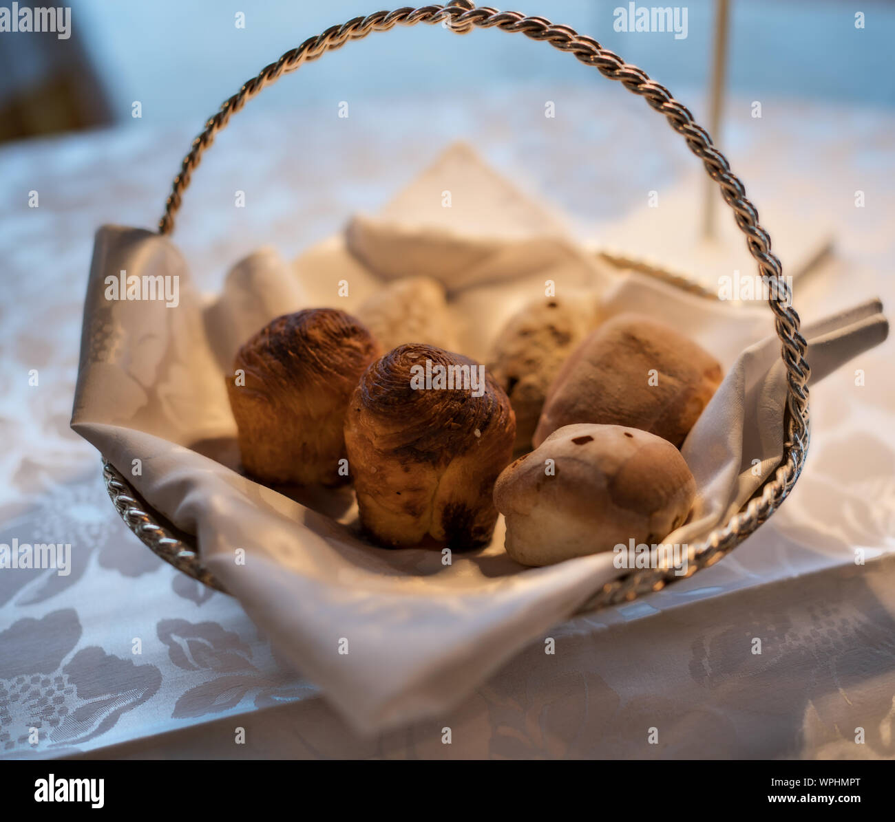 Selection of bread in a decorative basket Stock Photo - Alamy