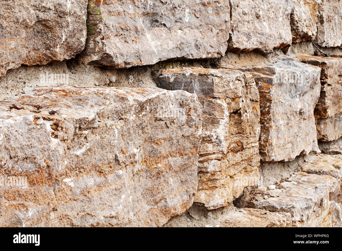 weathered wall of big rough limestone blocks, side view, detail Stock Photo - Alamy
