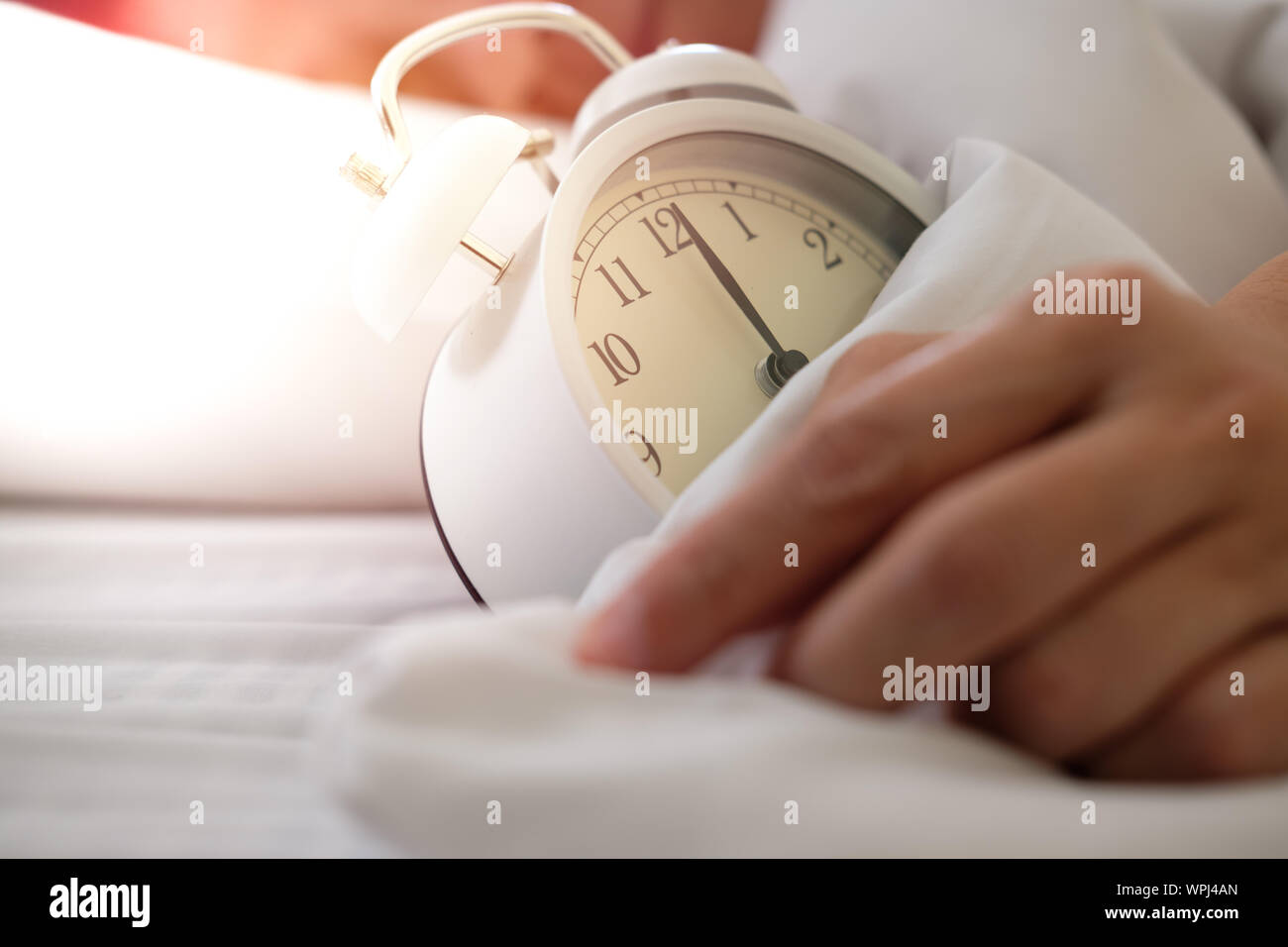 Women are hugging the alarm clock in the morning Stock Photo - Alamy